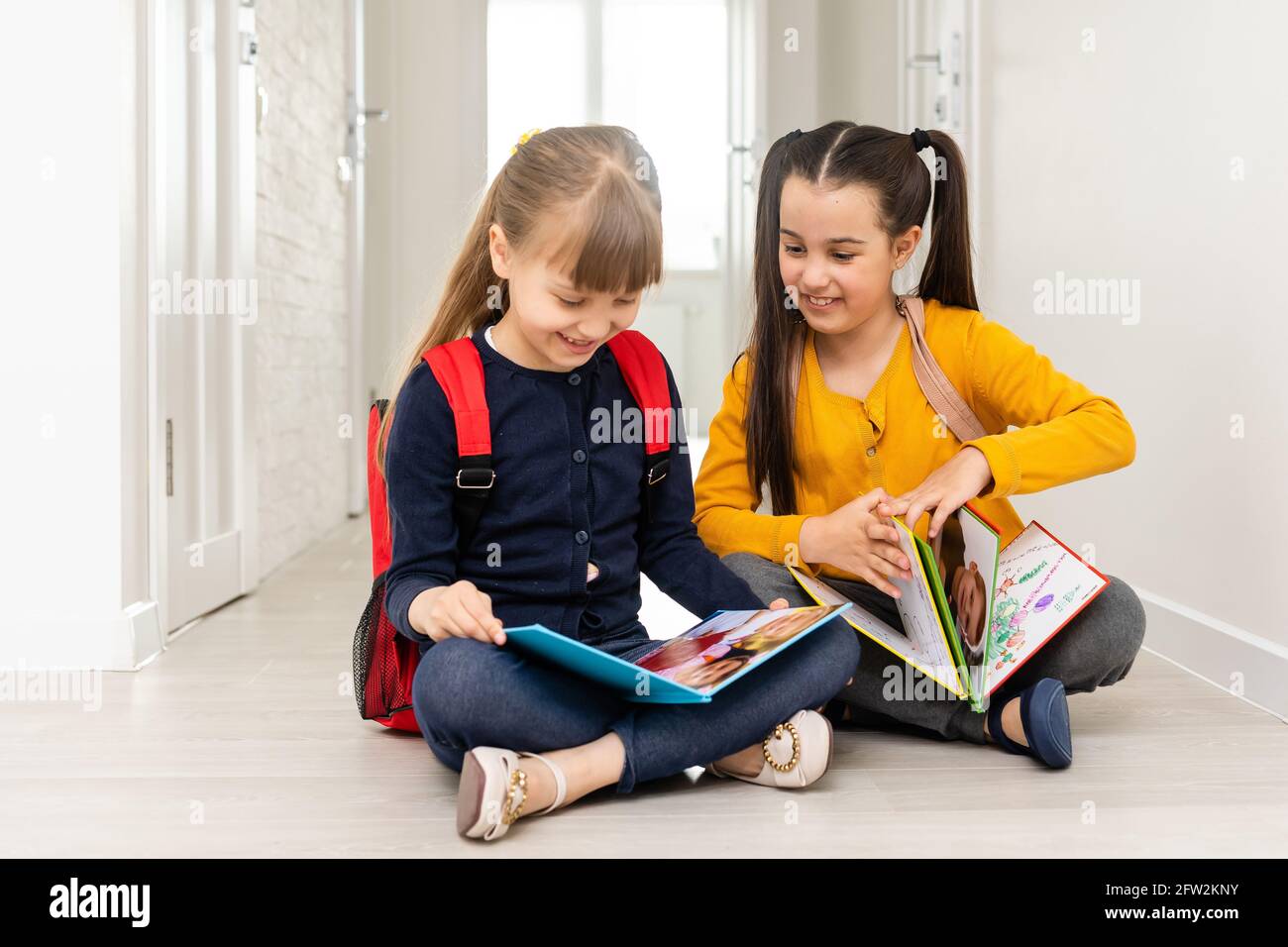 two pretty young schoolgirls. girls carry notebooks Stock Photo - Alamy