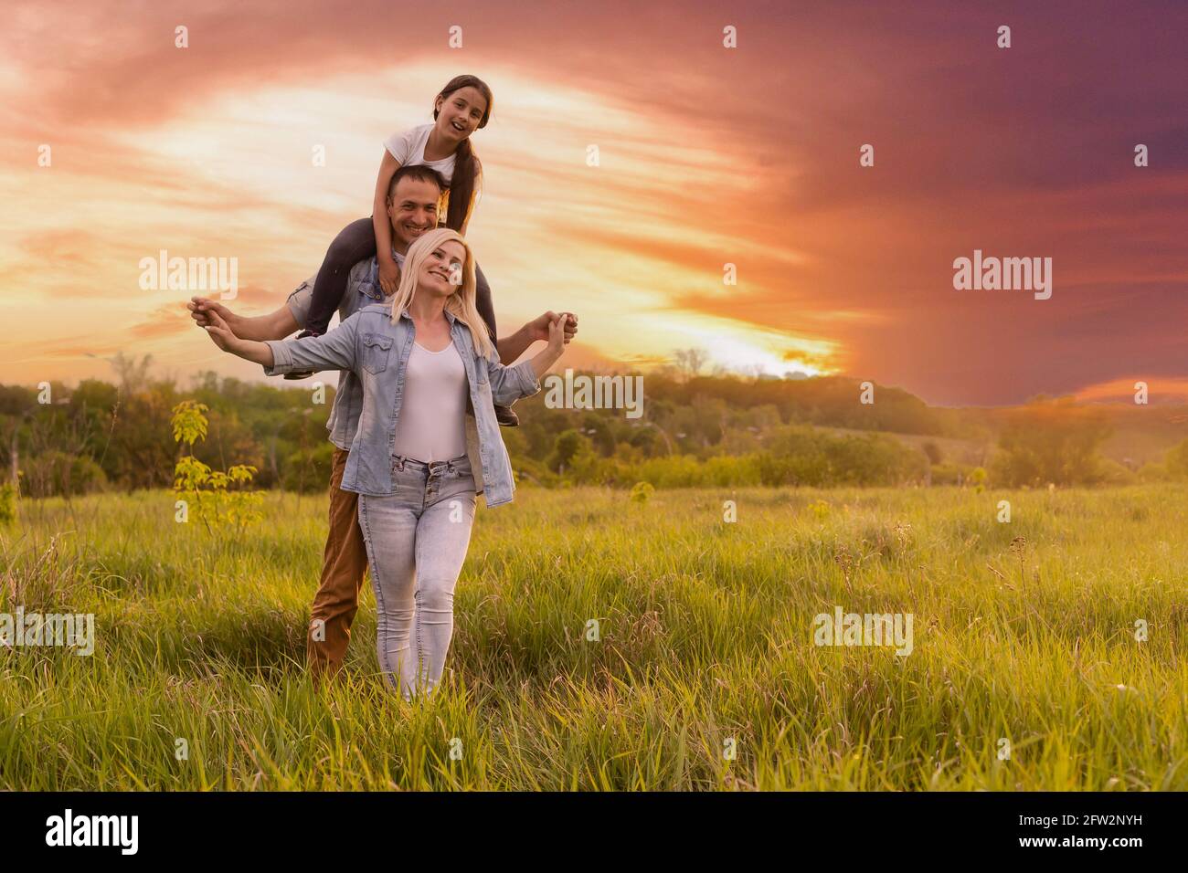 Happy family: mother, father, child daughter on nature on sunset Stock ...