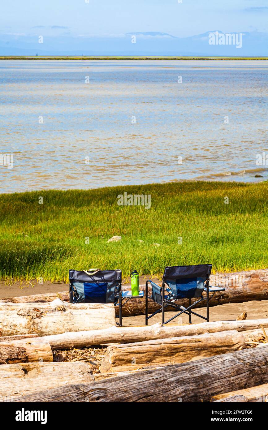 Two empty chairs among driftwood logs at Gary Point Park in Steveston ...