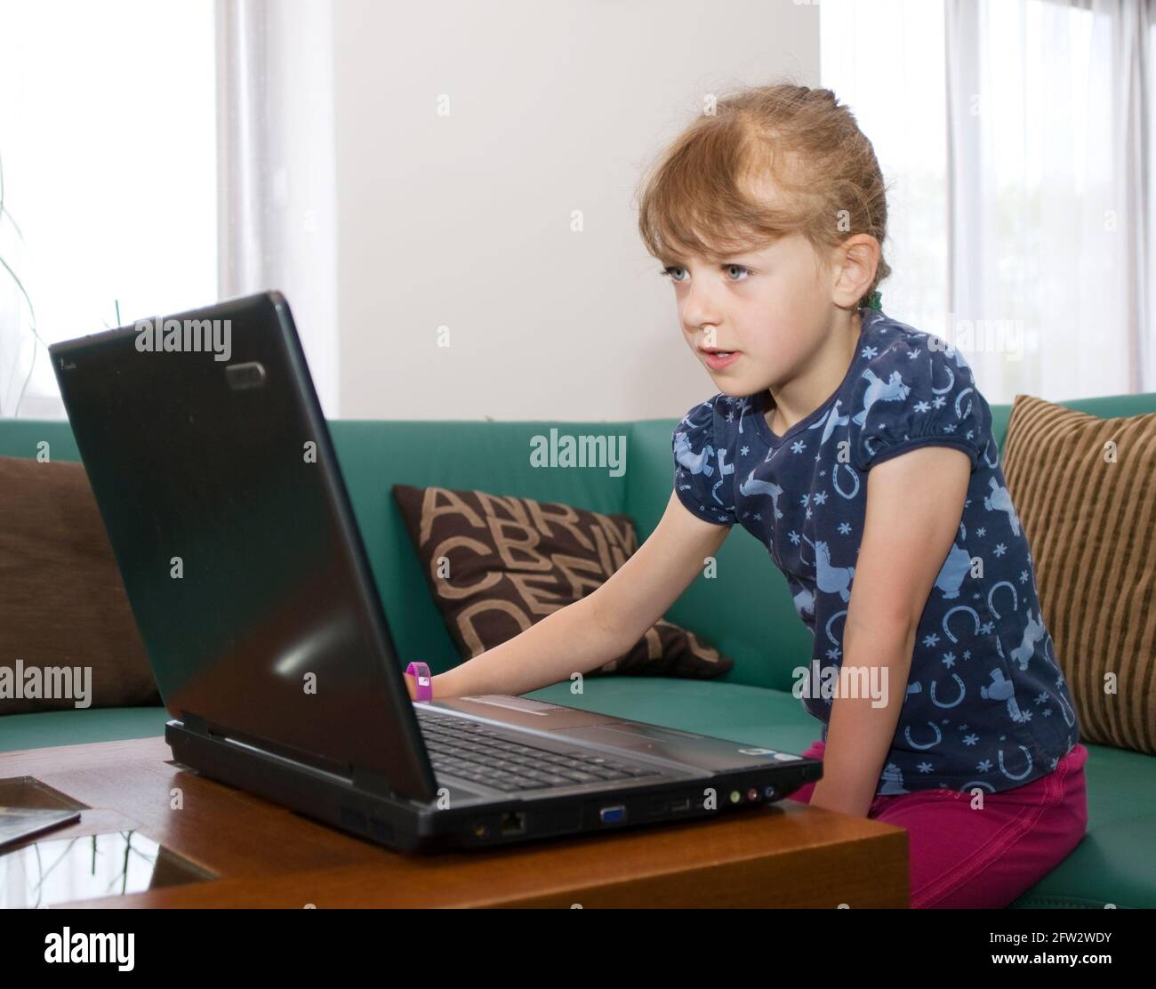 Pretty girl gaming on notebook Stock Photo - Alamy