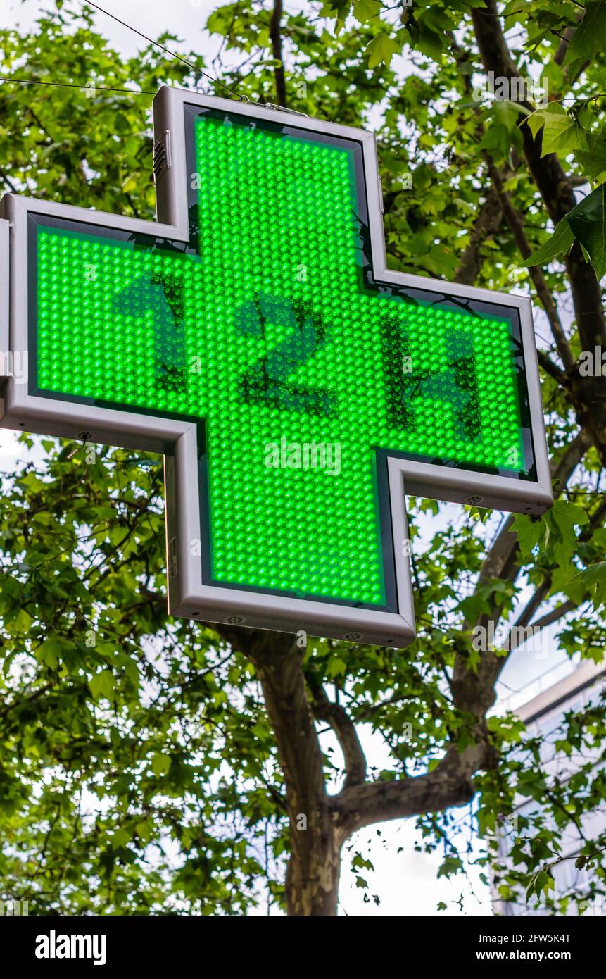 Pharmacy indicated by a green cross sign Stock Photo - Alamy