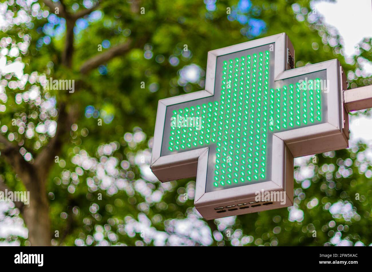 Pharmacy indicated by a green cross sign Stock Photo - Alamy