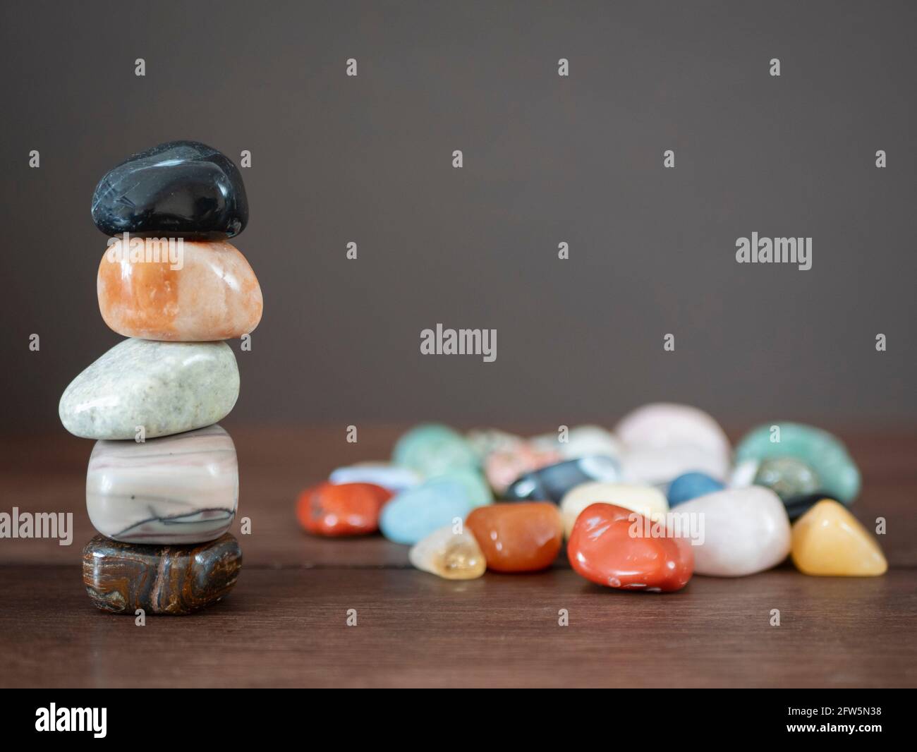 Pile of colorful gemstones. Pyramid of five smooth stones Stock Photo ...