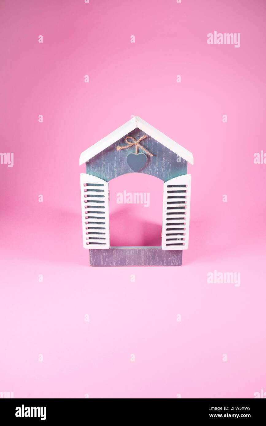 Soft blue handmade wooden window with open shutters on pink background ...