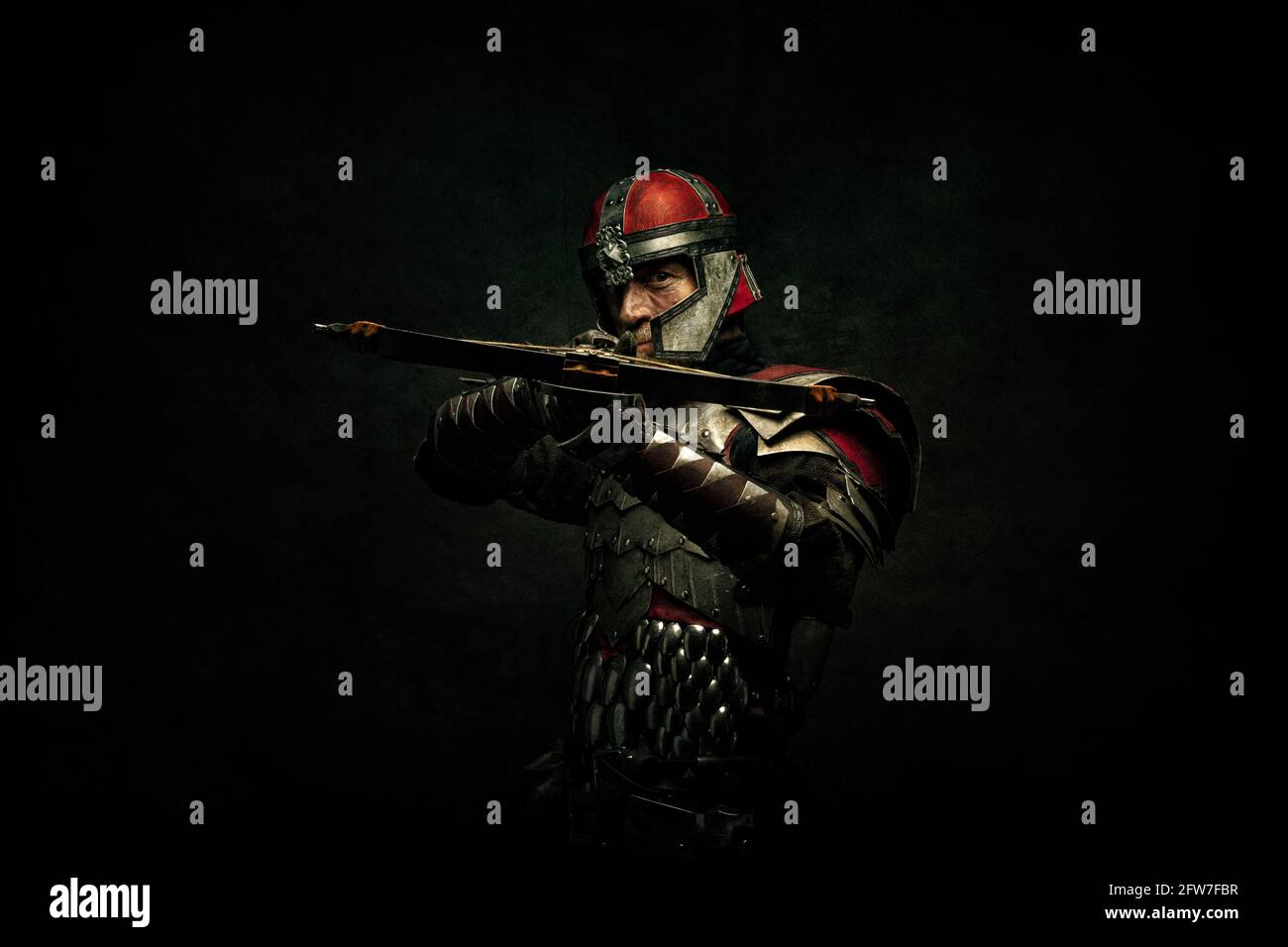Portrait of a medieval fighter holding a crossbow in his hands Stock ...