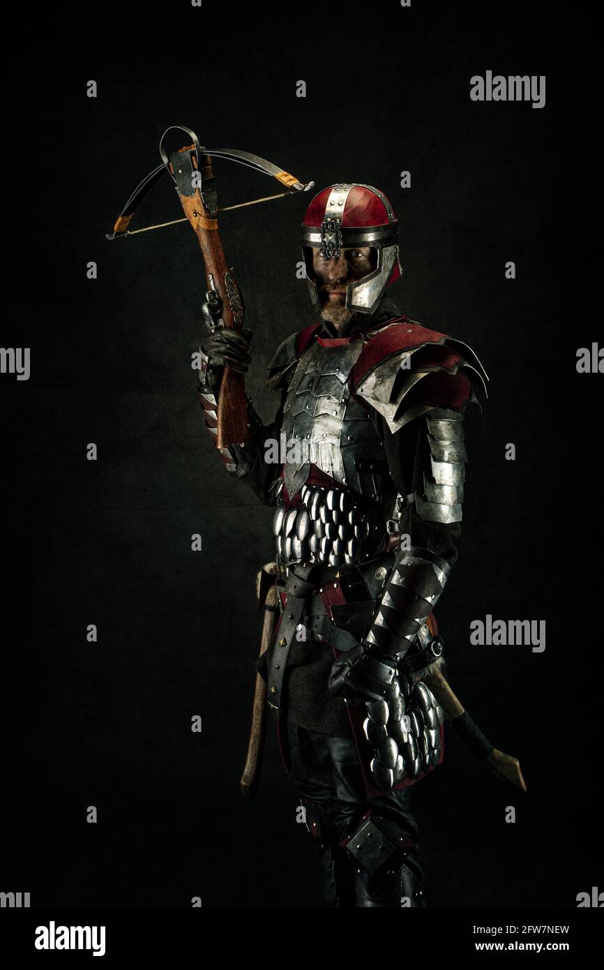 Portrait of a medieval fighter holding a crossbow in his hands Stock ...