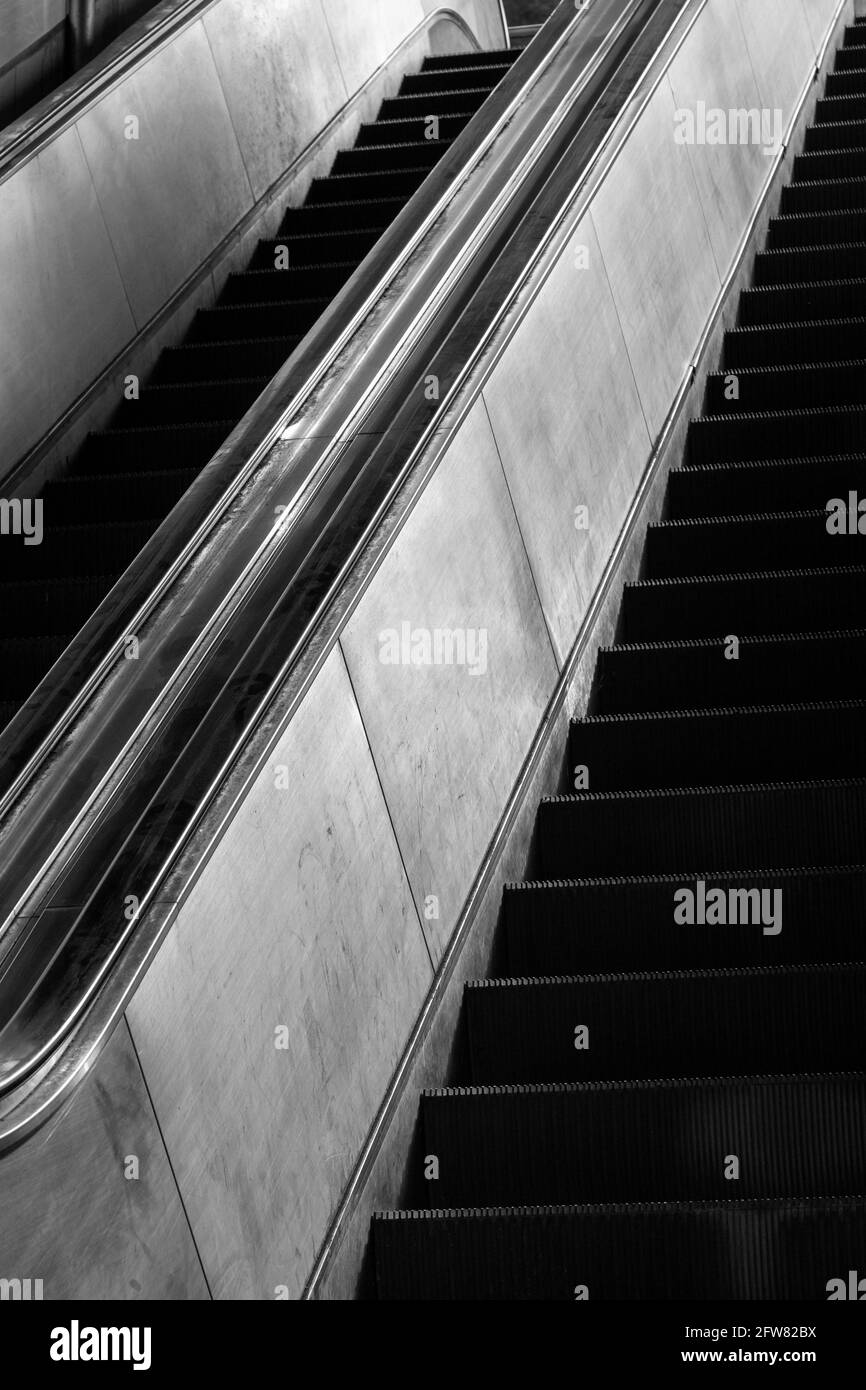 approach to an escalator with its handrail, structure inside a building ...