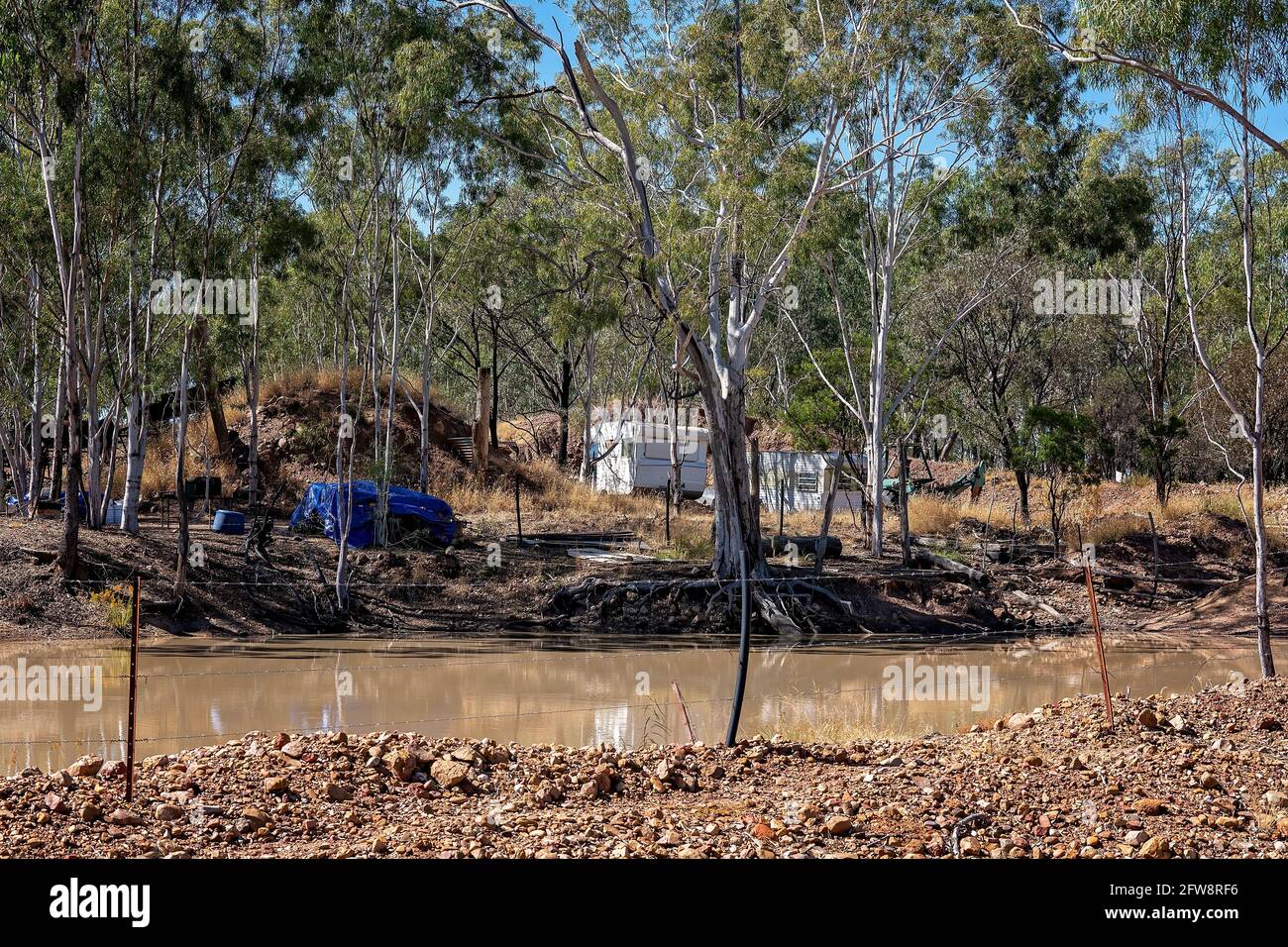 Old caravans used as homes beside a dam for sapphire prospectors in the ...