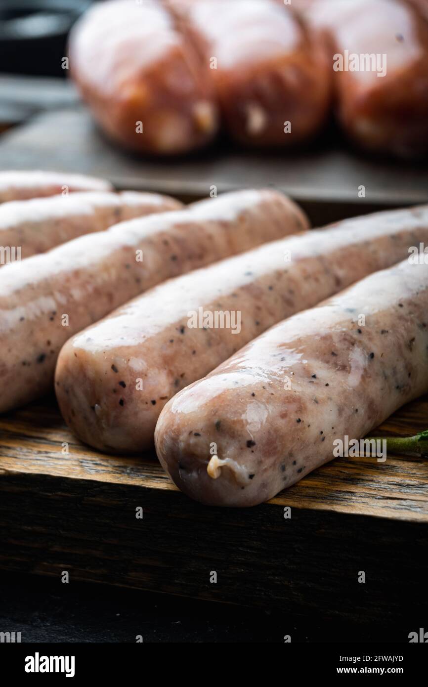 Traditional chicken sausages, on black background Stock Photo - Alamy