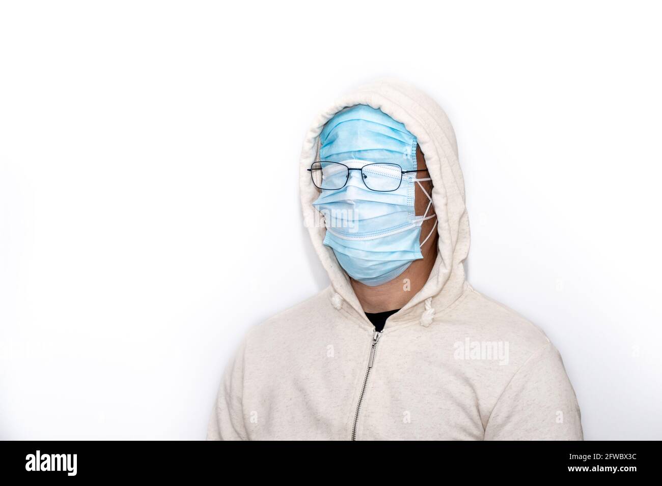 Portrait of a man with his face covered in masks and glasses above them ...