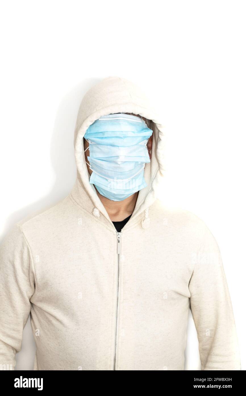 Vertical portrait of hooded man with his face covered in protective ...