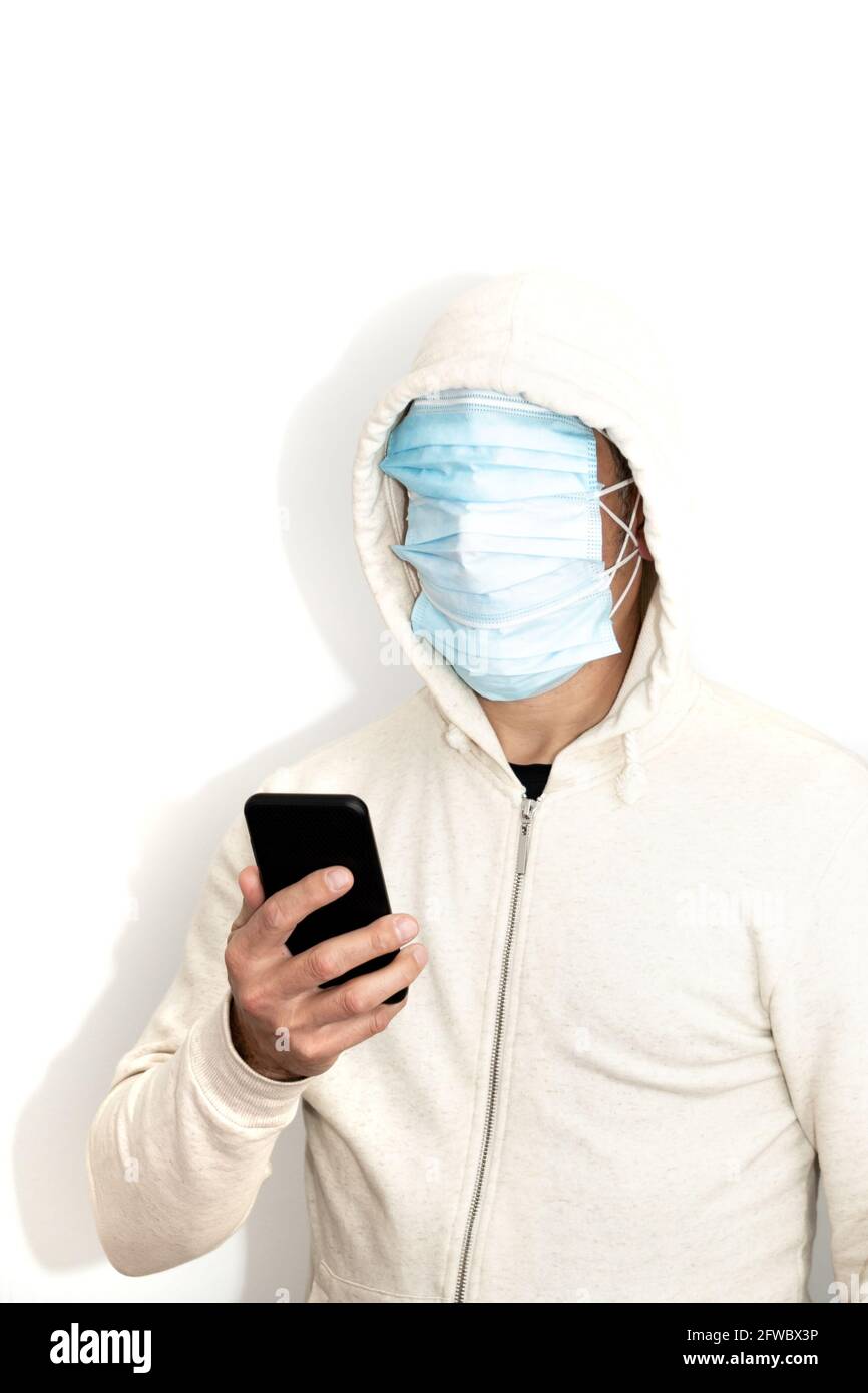 Masked man mobile phone hi-res stock photography and images - Alamy