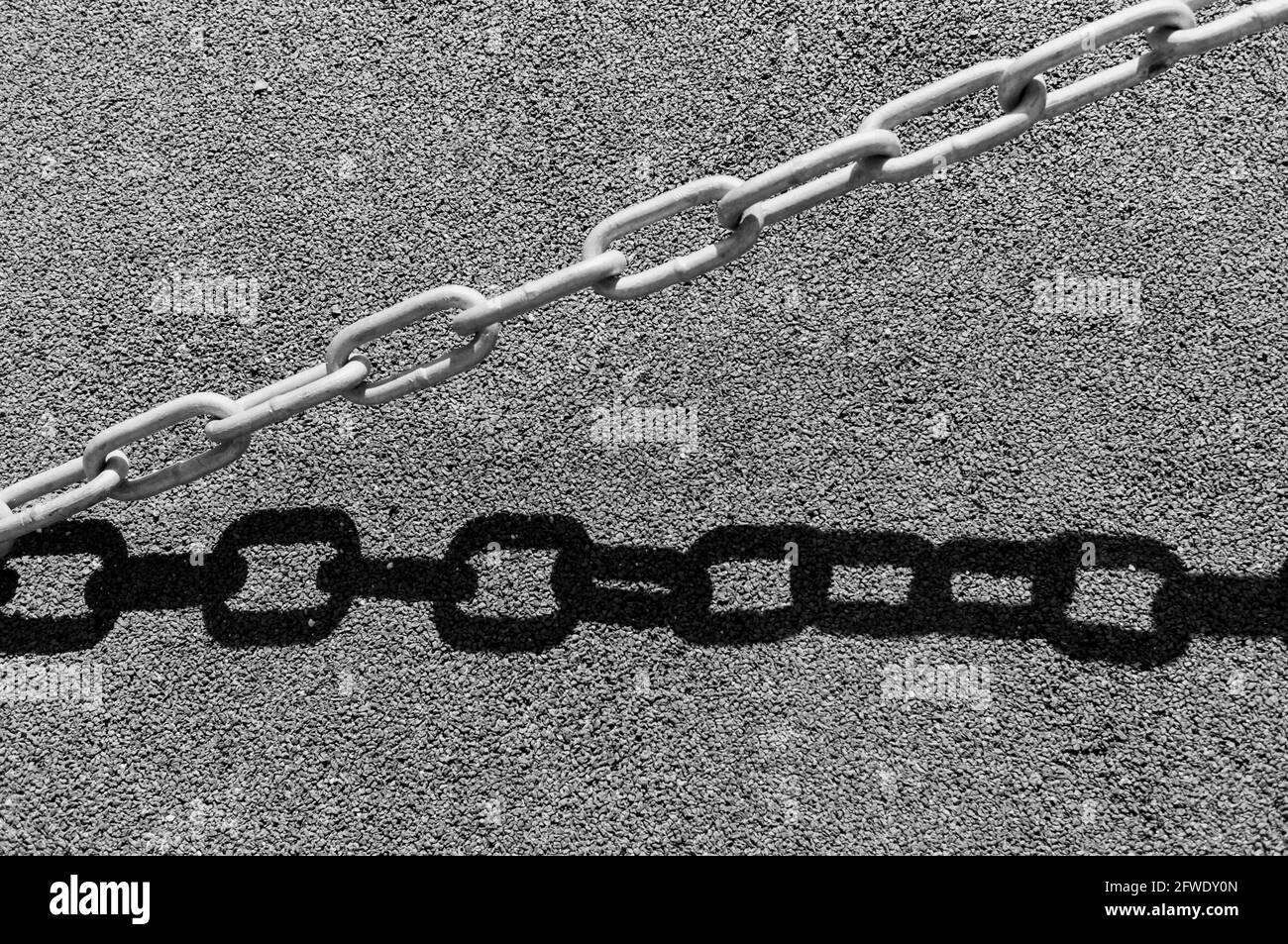Gray chain links shadow on a concrete surface Stock Photo - Alamy