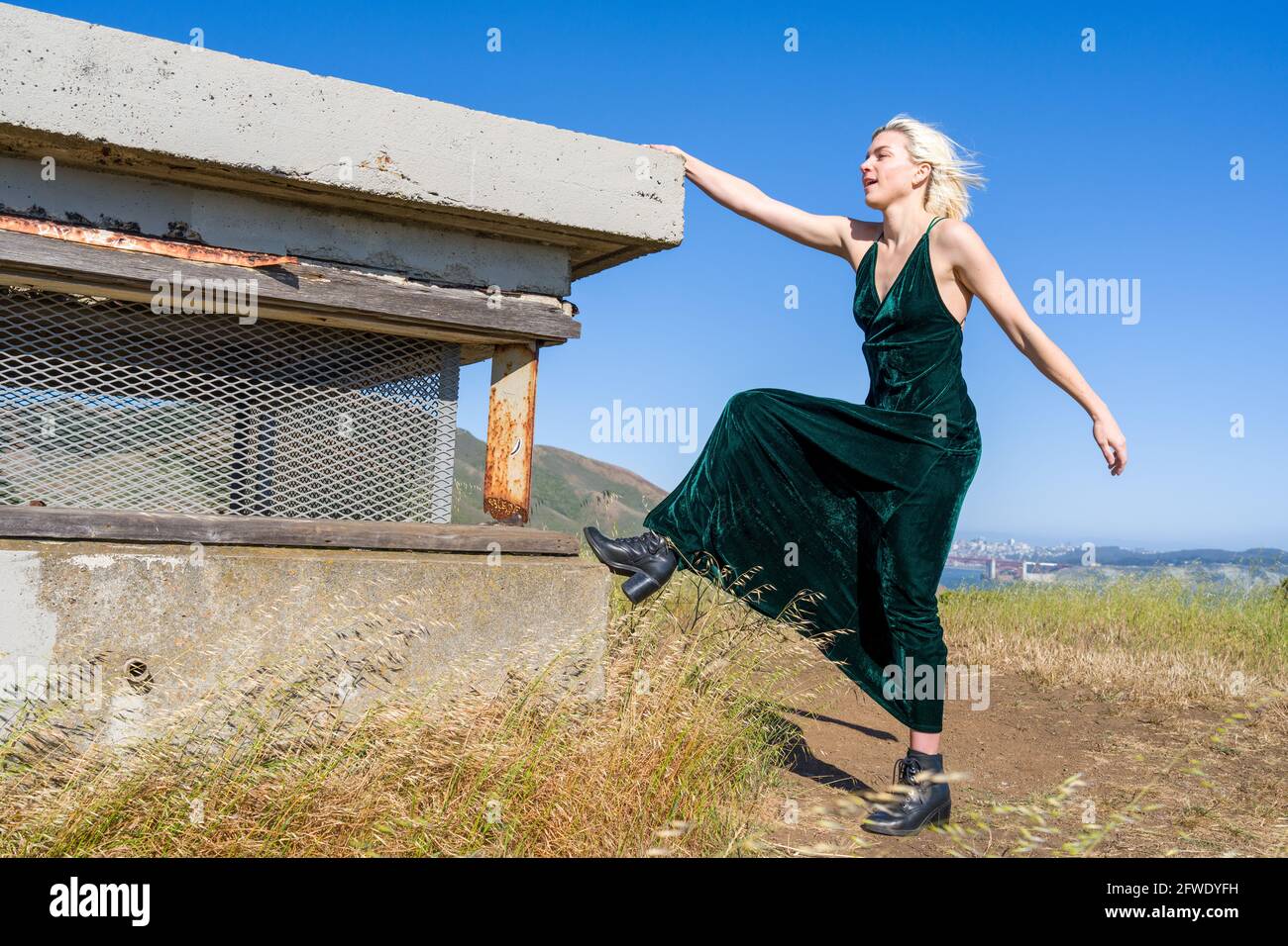 Fashion in Unusual Places, Young Woman Climbing Concrete Gun Battery ...