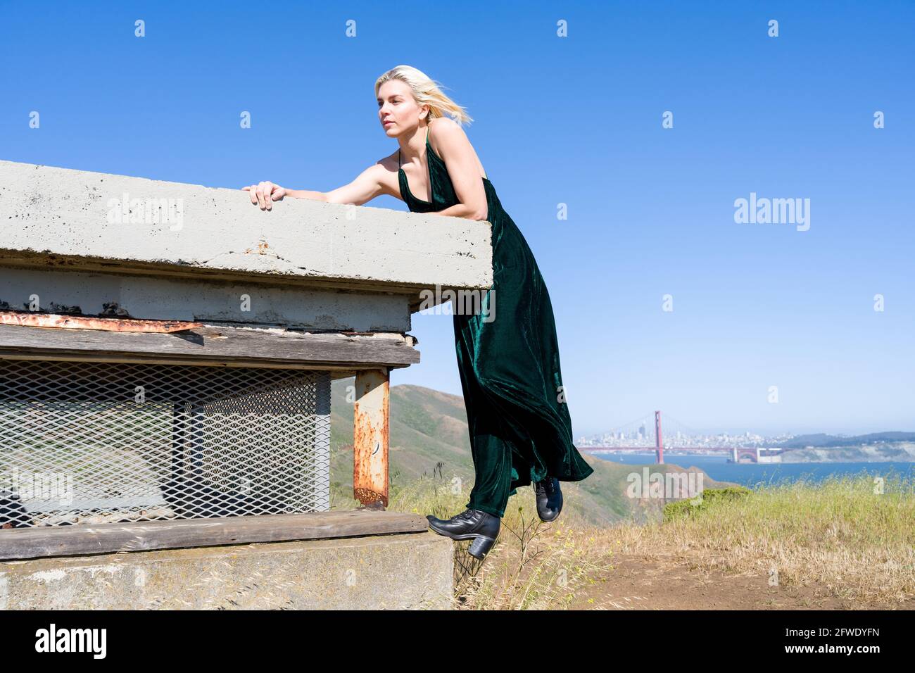 Fashion in Unusual Places, Young Woman Climbing Concrete Gun Battery ...