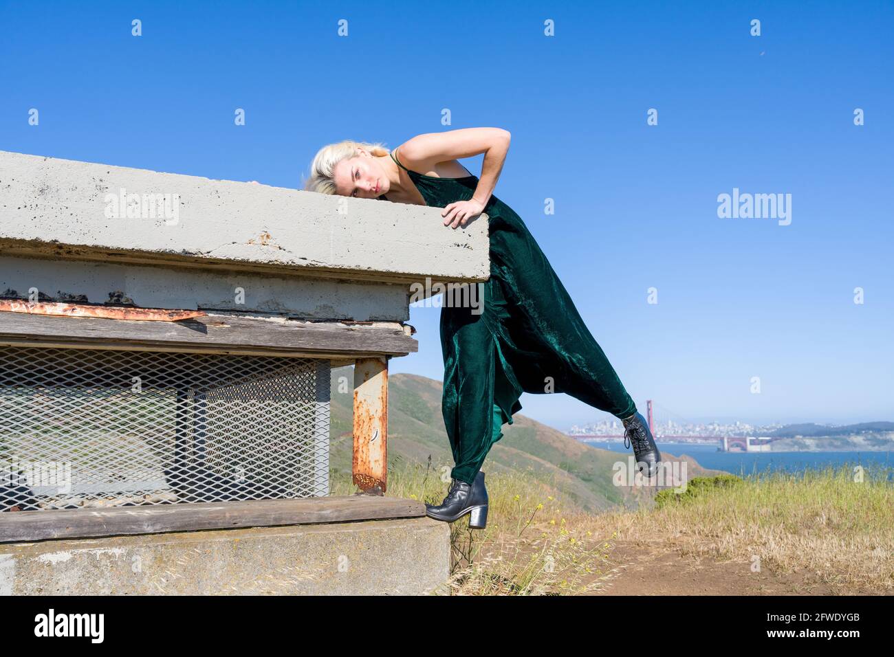 Fashion in Unusual Places, Young Woman Climbing Concrete Gun Battery ...