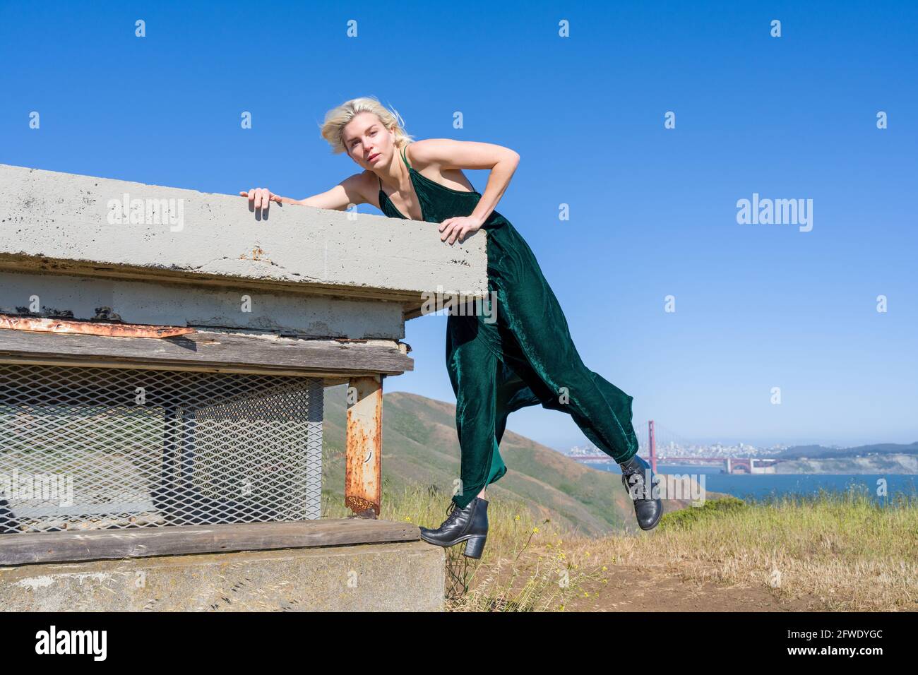 Fashion in Unusual Places, Young Woman Climbing Concrete Gun Battery ...