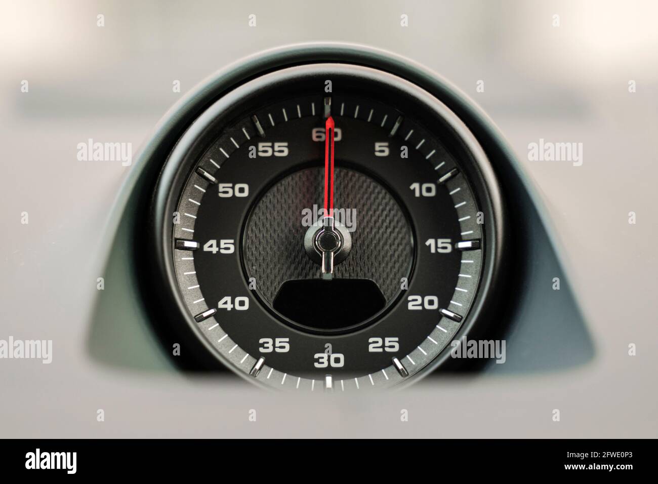 Classic design watch, red hour hand on black dial and white numerals ...