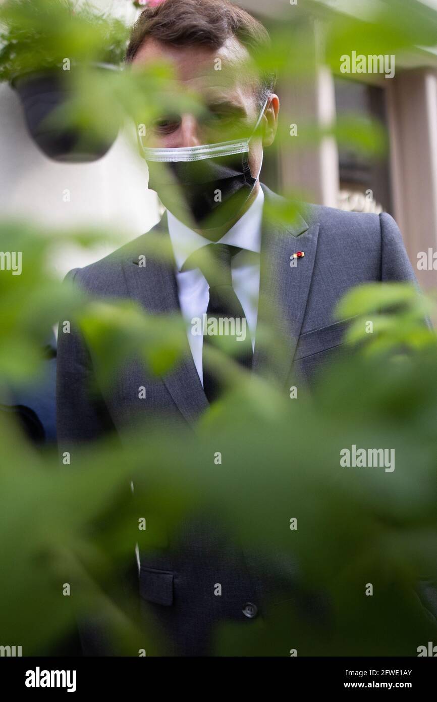 French President Emmanuel Macron walk next to plants during a visit to ...