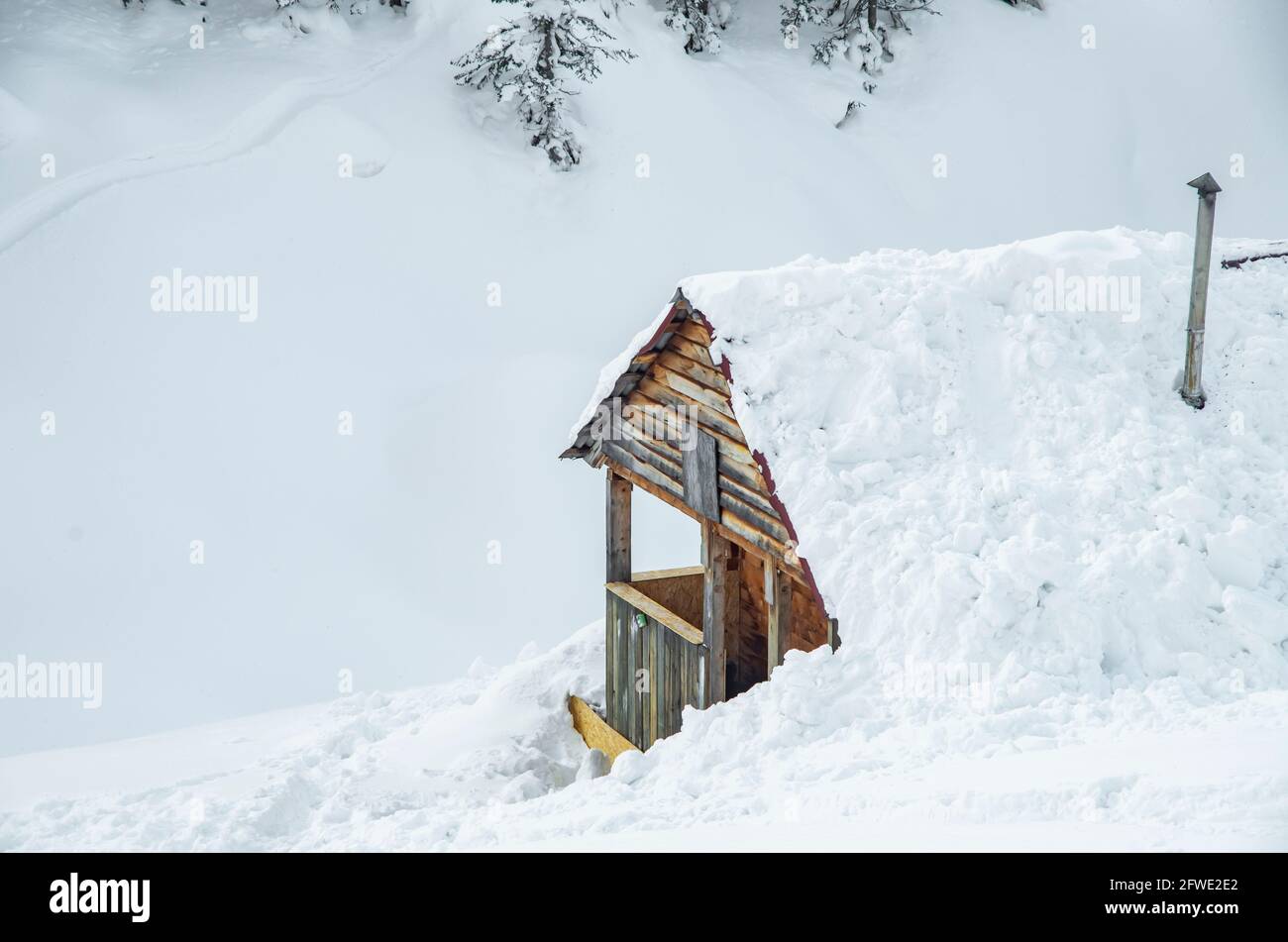 Minimalist winter landscape with wooden house in snowy mountains ...