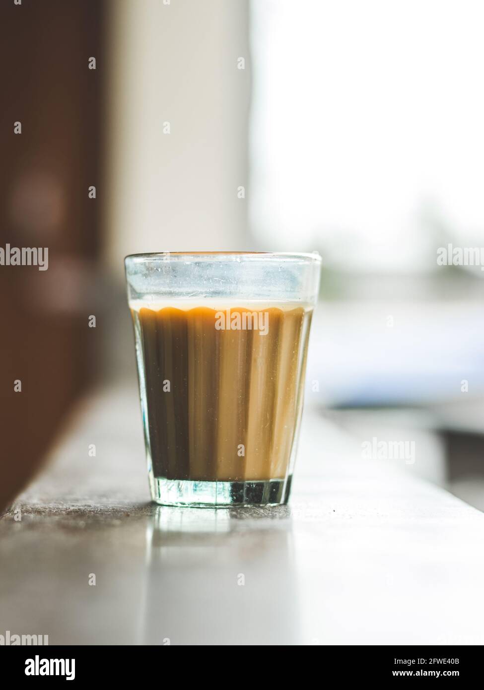 Indian chai in glass cups with metal kettle and other masalas to make ...