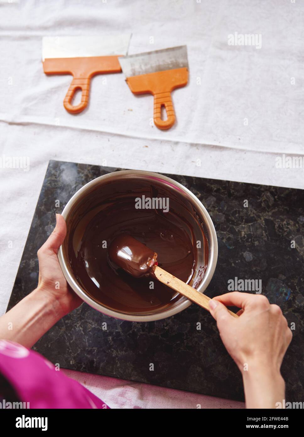 Chocolatier mixing melted liquid chocolate hi-res stock photography and ...