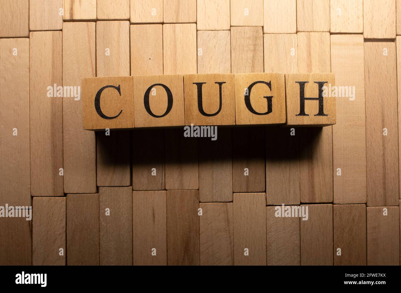 The word Cough was created from wooden cubes. Health and life Close up ...