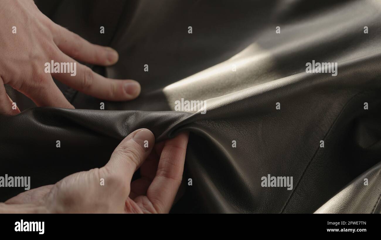 Man hand touching soft leather with sun shining from a window, wide ...