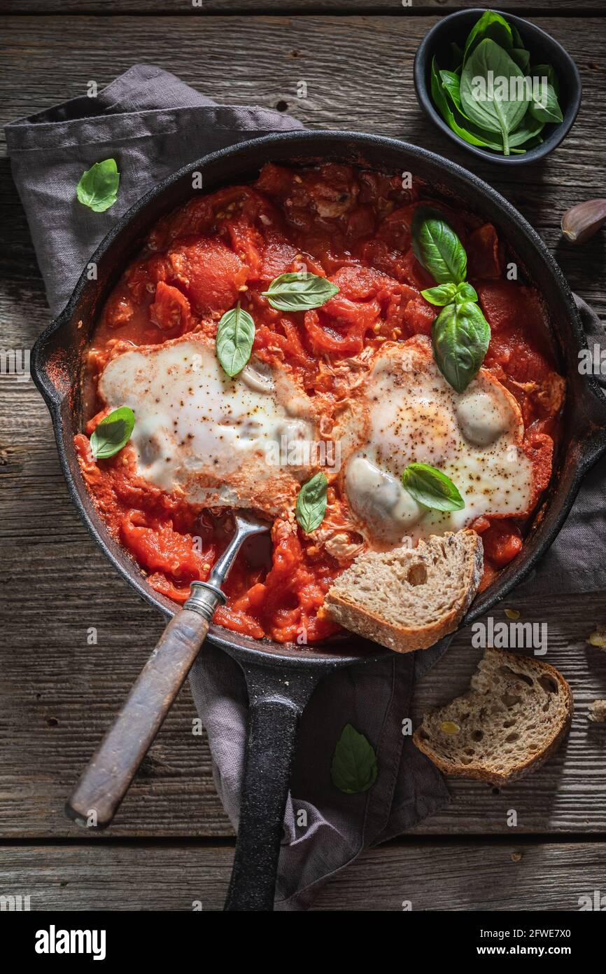 Shakshuka served with wholemeal bread for breakfast. Tunisian cuisine ...