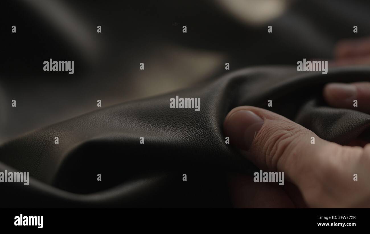 Man hand touching soft leather with sun shining from a window, wide ...