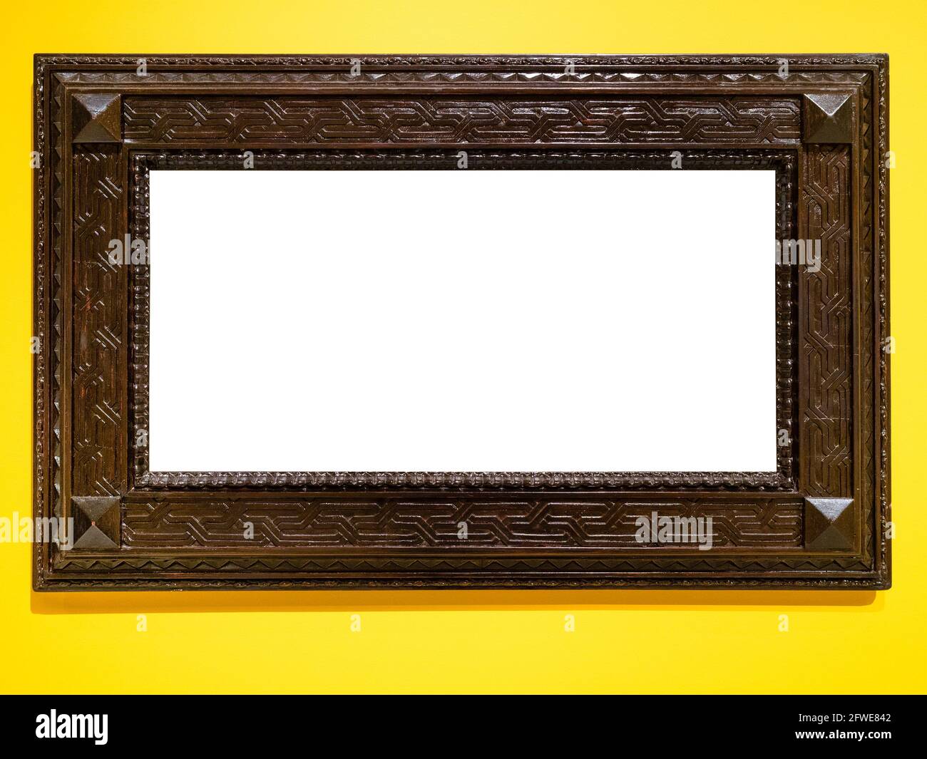 wide dark brown carved wooden picture frame with cutout canvas on ...