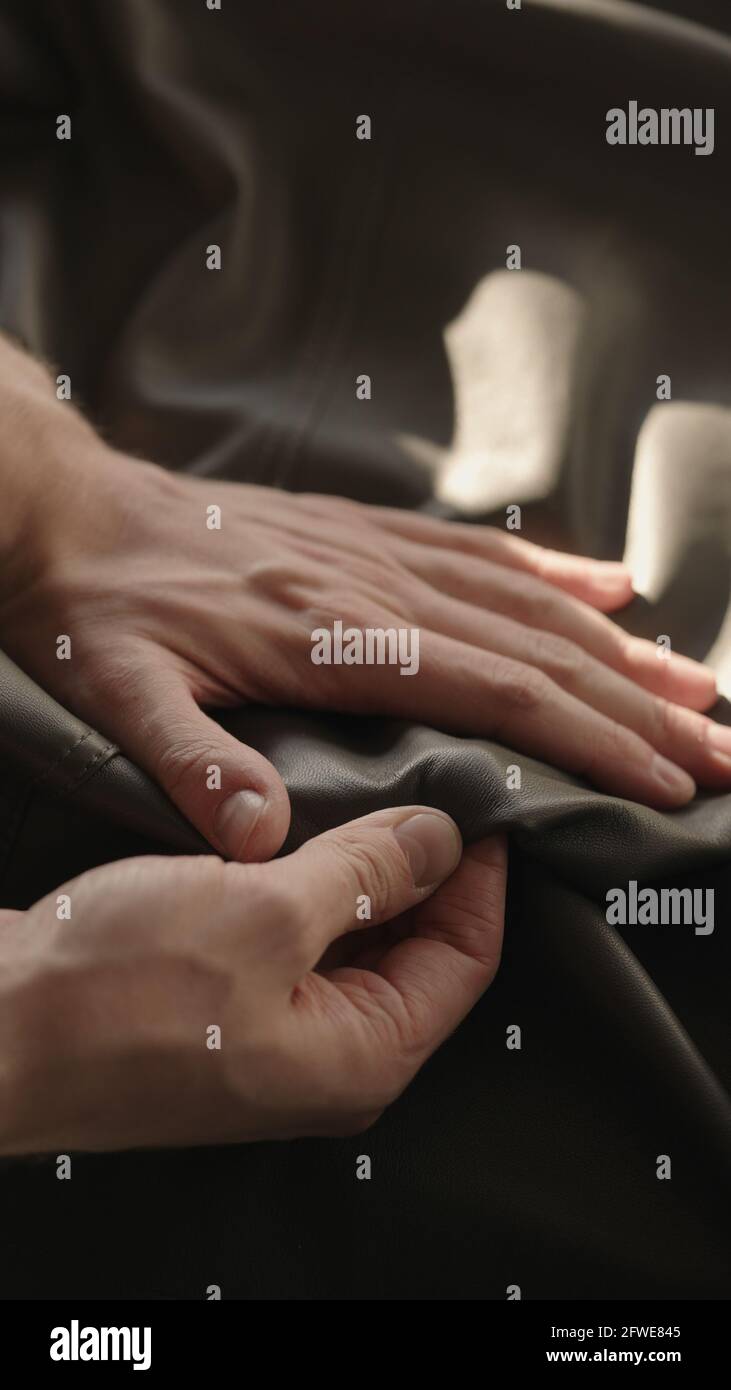 Man hand touching soft leather with sun shining from a window, wide ...