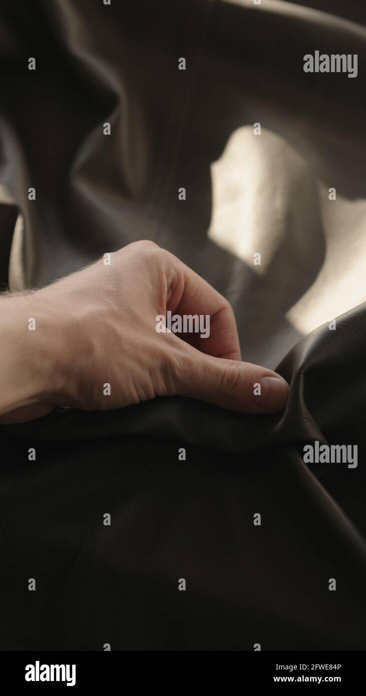 Man hand touching soft leather with sun shining from a window, wide ...
