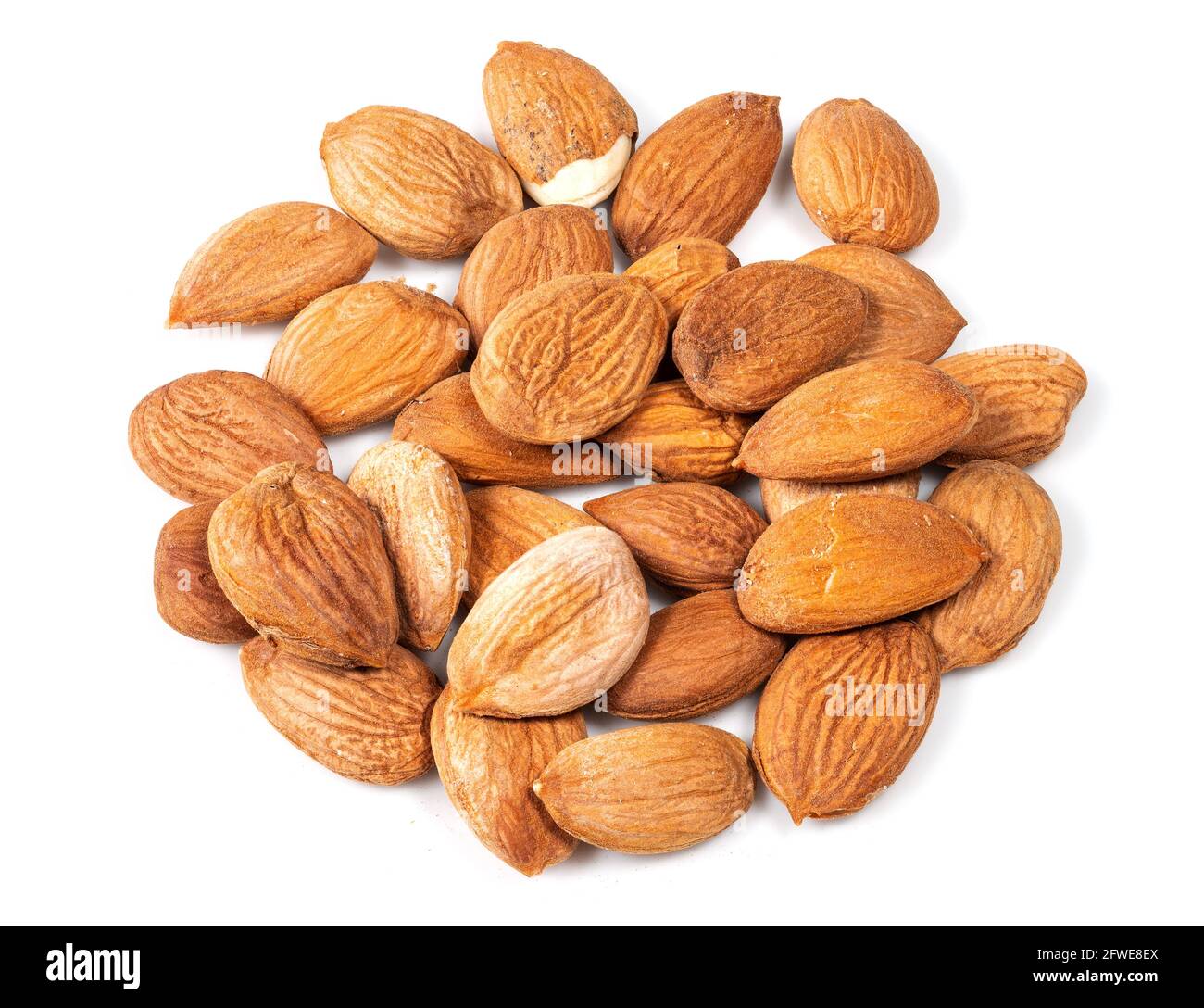 pile of of apricot kernels closeup on white background Stock Photo - Alamy