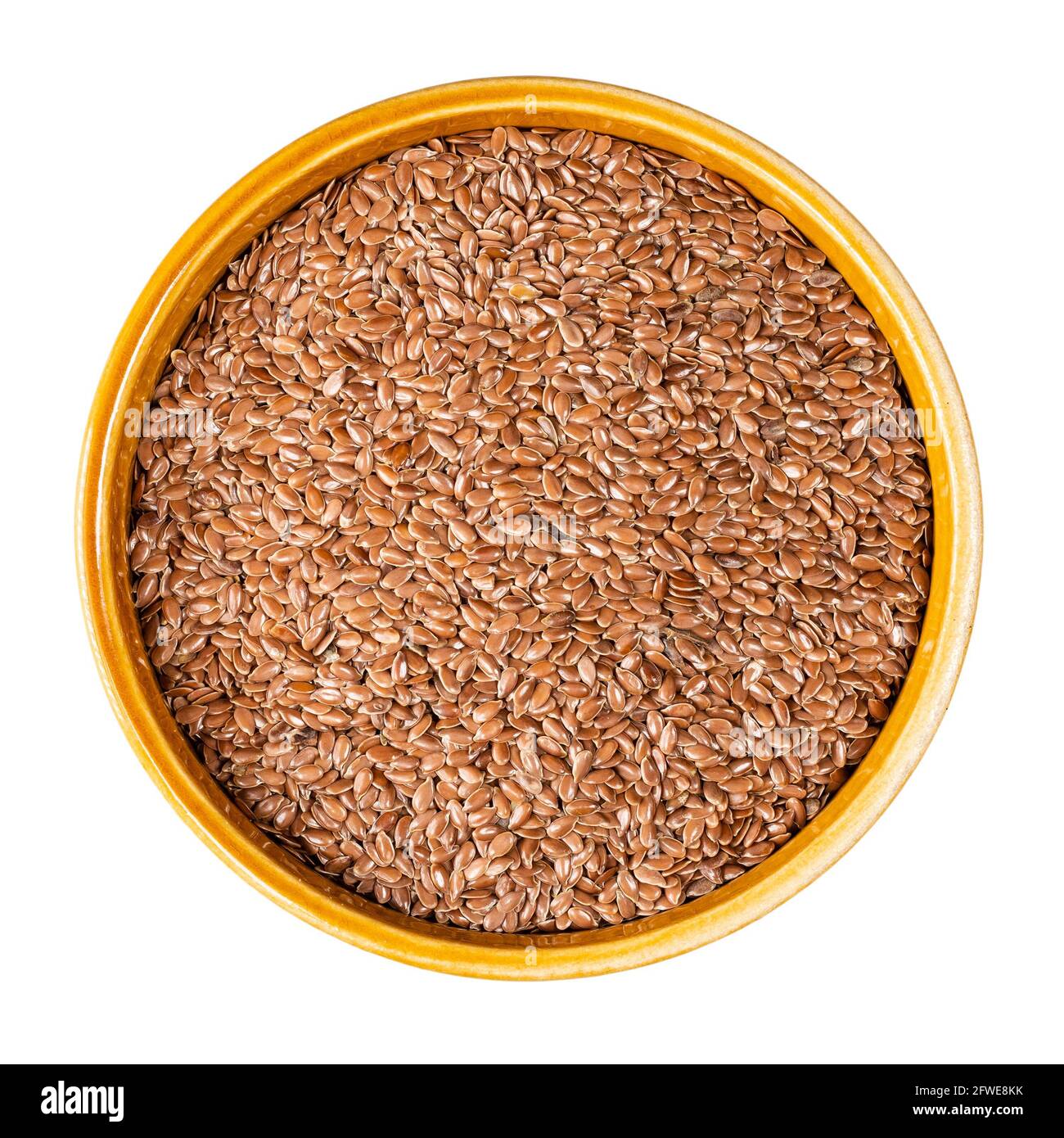 Top View Of Brown Flax Seeds In Round Ceramic Bowl Cutout On White