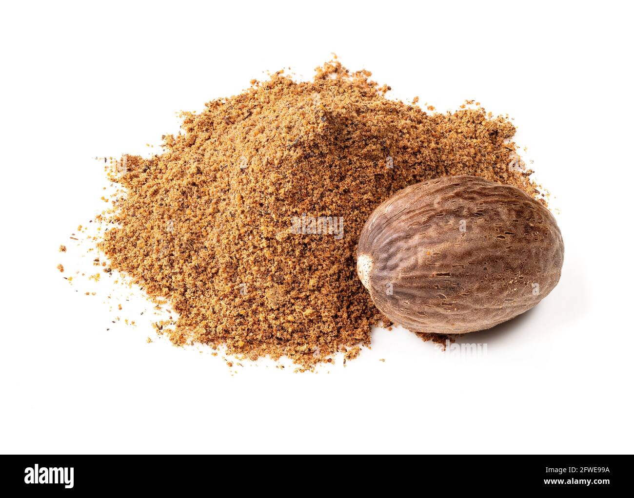 handful of whole nutmeg seed and powder closeup on white background ...