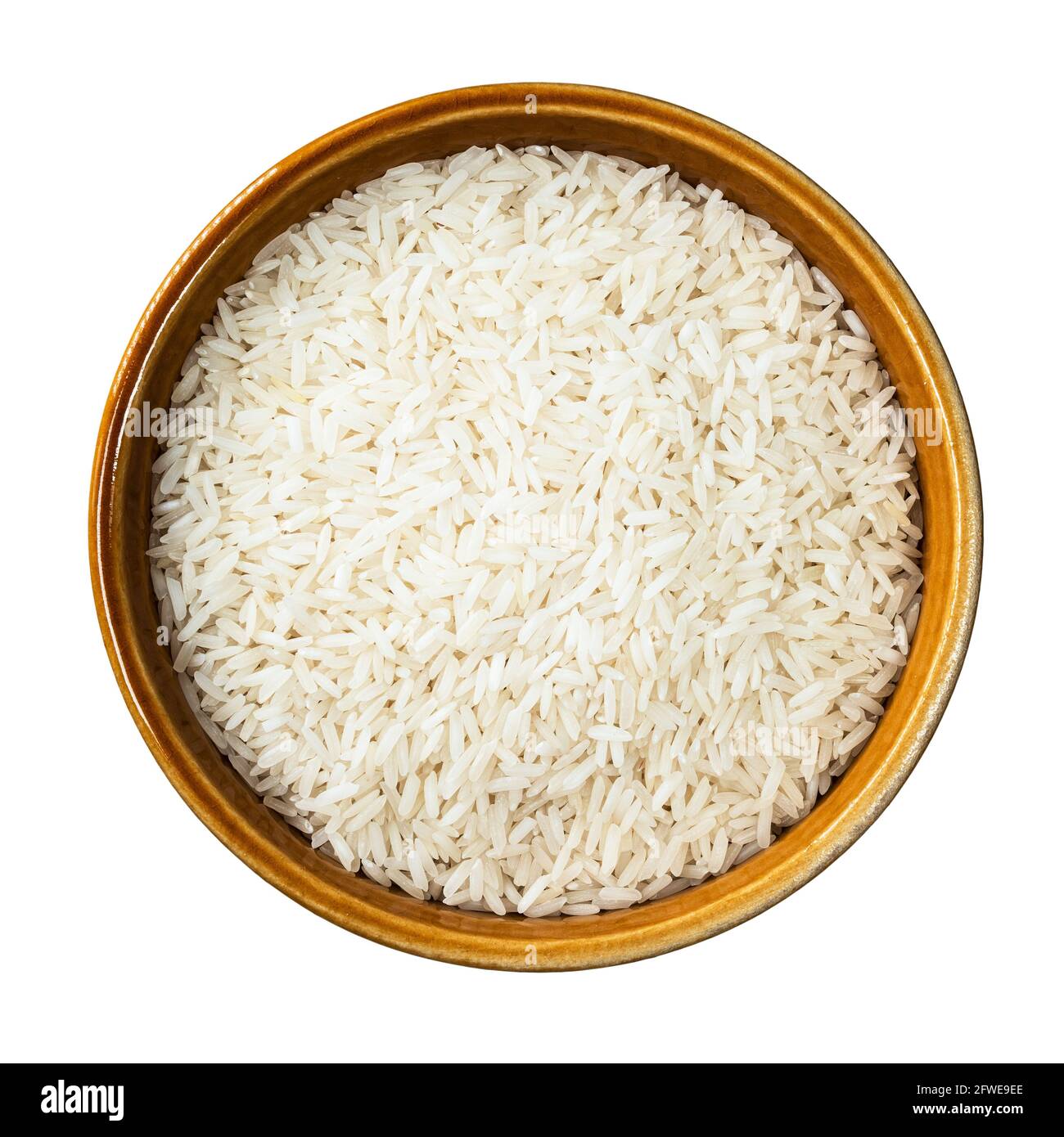 top view of raw long-grain polished rice in round bowl cutout on white ...