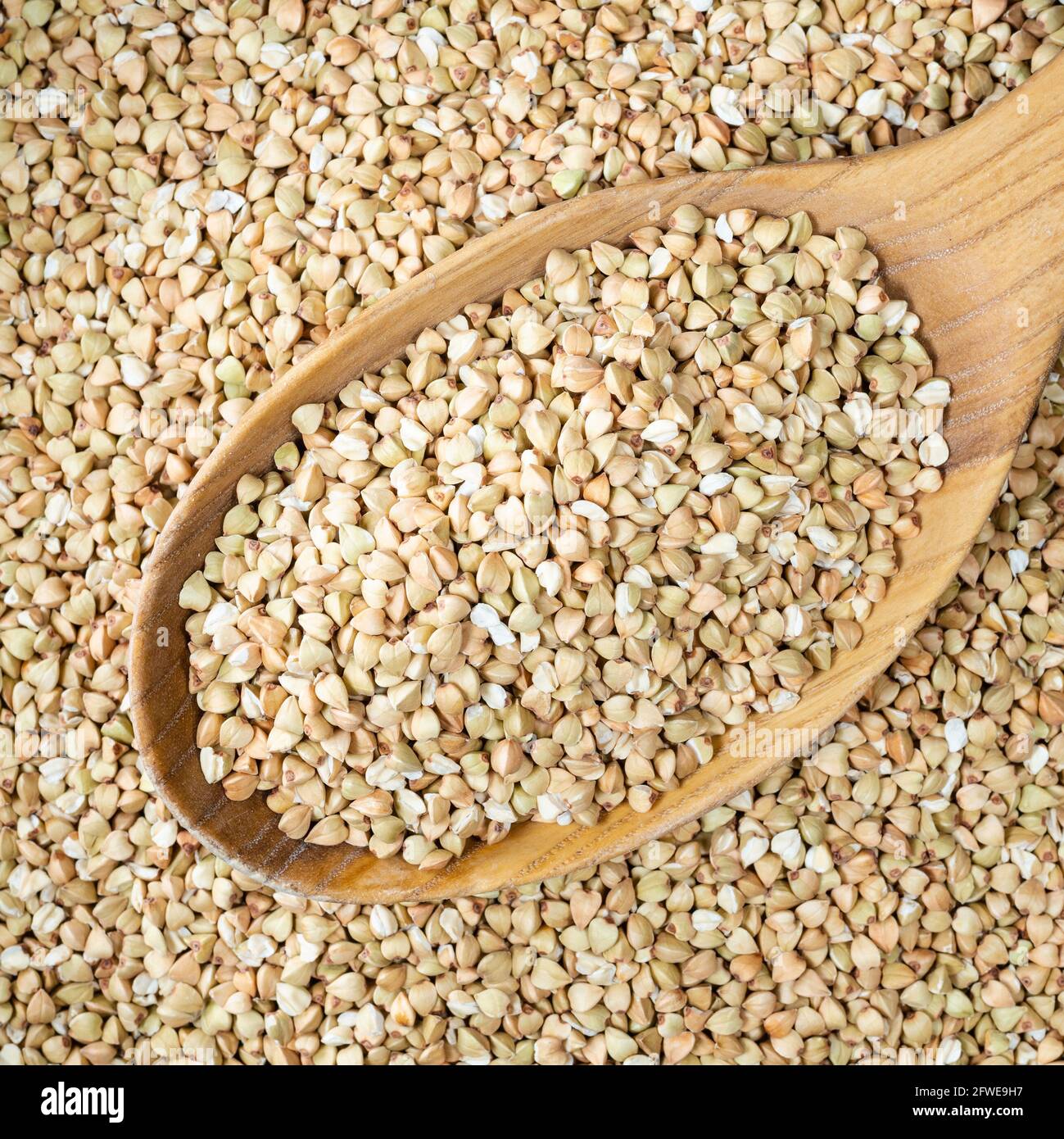 top view of green buckwheat grains in wooden spoon closeup Stock Photo ...