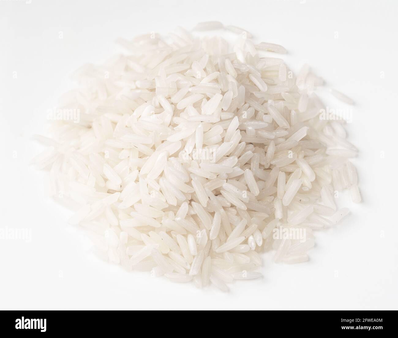 pile of raw long-grain polished rice closeup on white background Stock ...