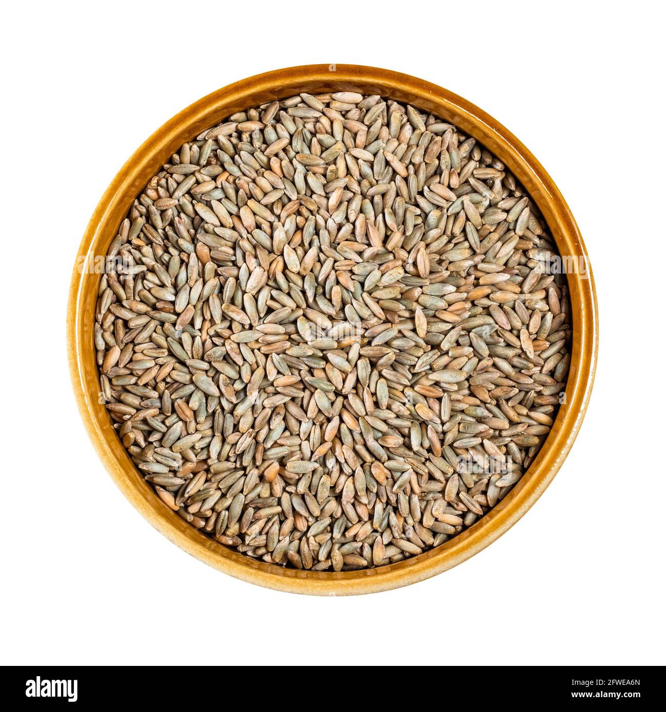 top view of husked rye grains in round ceramic bowl cutout on white ...