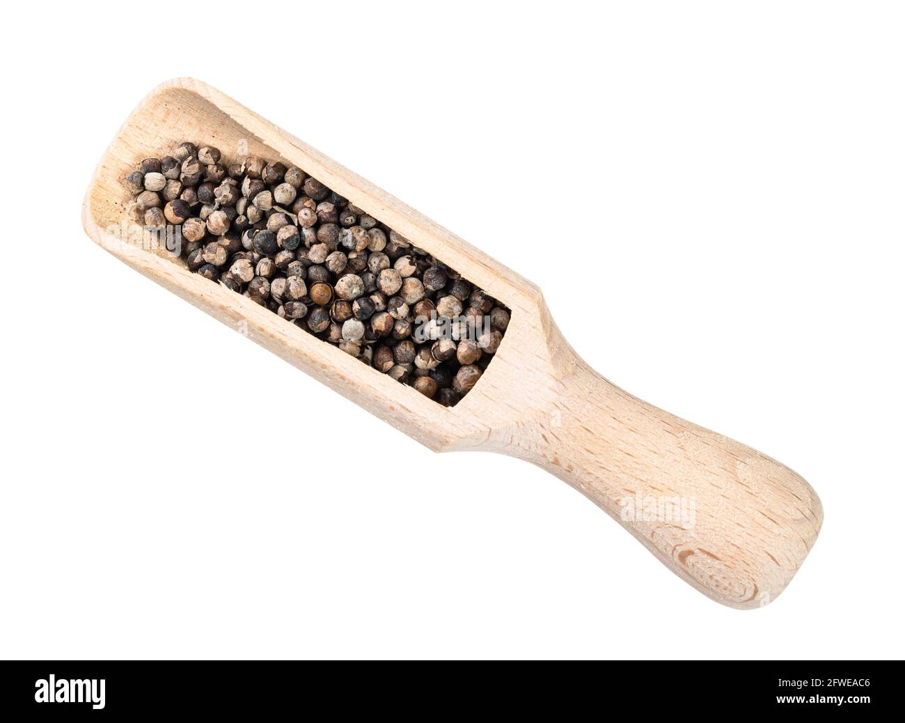 top view of monk's pepper (Vitex) in wood scoop cutout on white ...