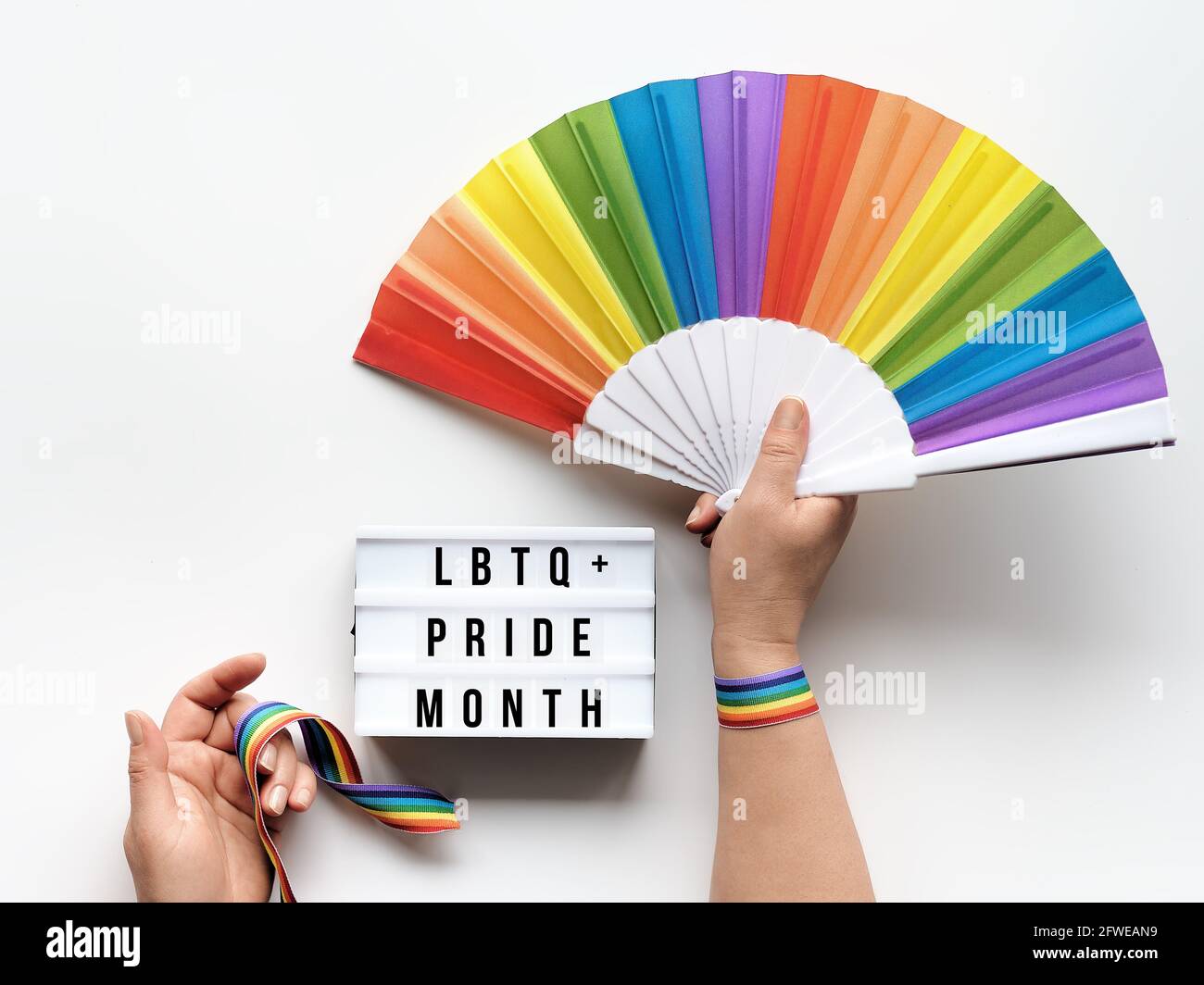 LGBTQ pride month decor. Text Happy Pride Month on lightbox. Rainbow ...