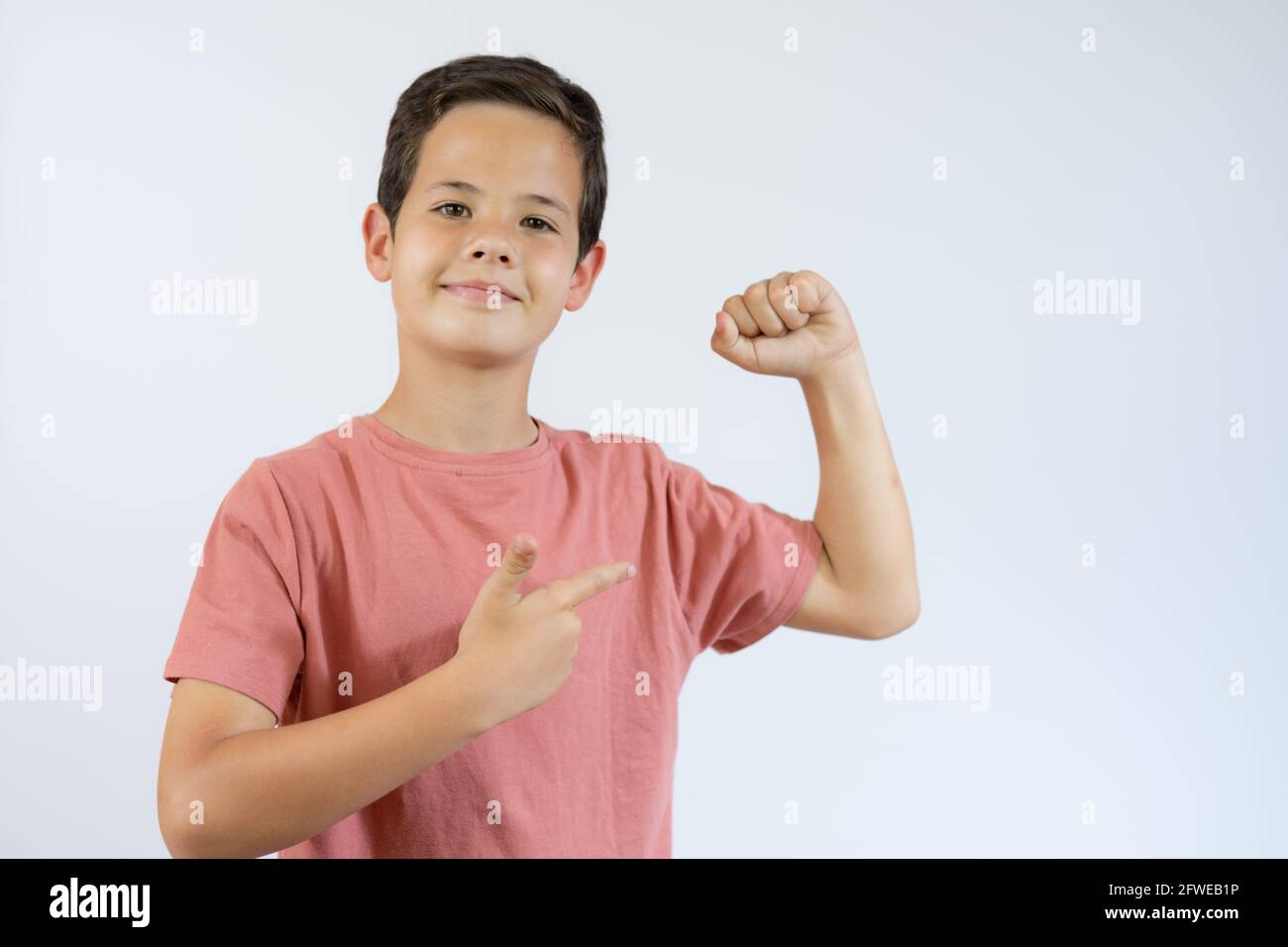 strong young beautiful boy points to the muscles of his arms Stock ...