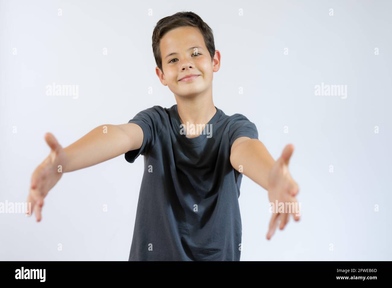 Let's hug. Portrait of friendly hospitable little boy in black T-shirt ...