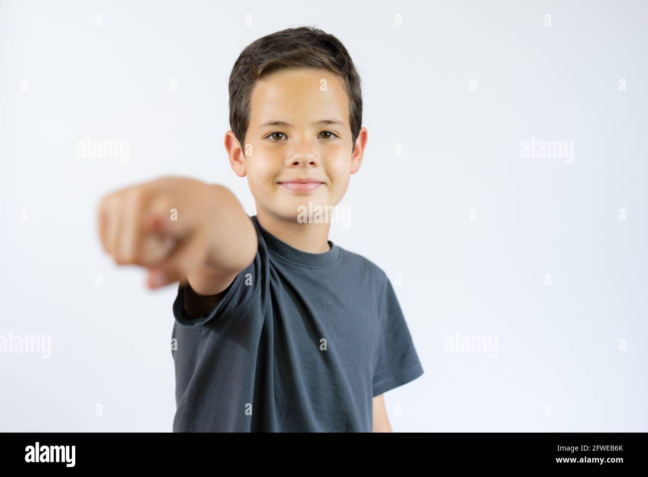 Boy standing and pointing on you over white background Stock Photo - Alamy