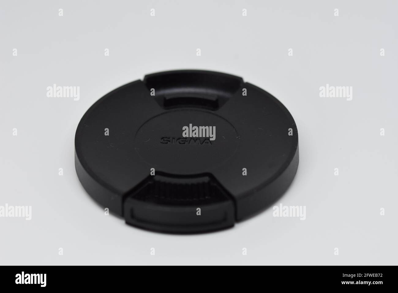 A black Sigma macro lens cap/cover with a clean white background Stock ...