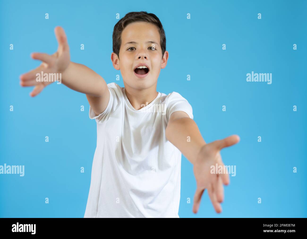 Let's hug. Portrait of friendly hospitable little boy in black T-shirt ...