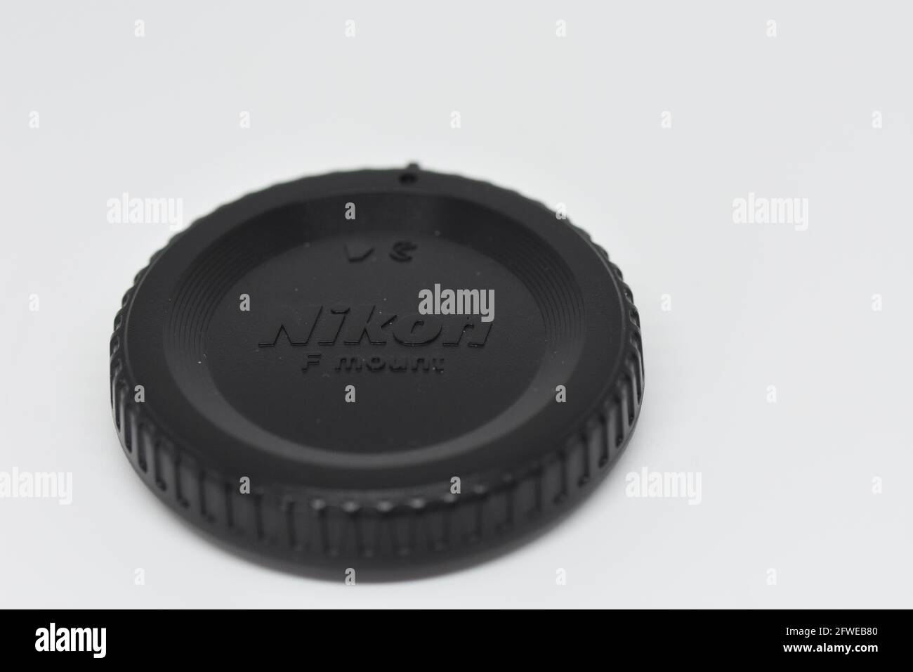 A camera cap/cover from a Nikon D3400 DSLR on a clean white background ...