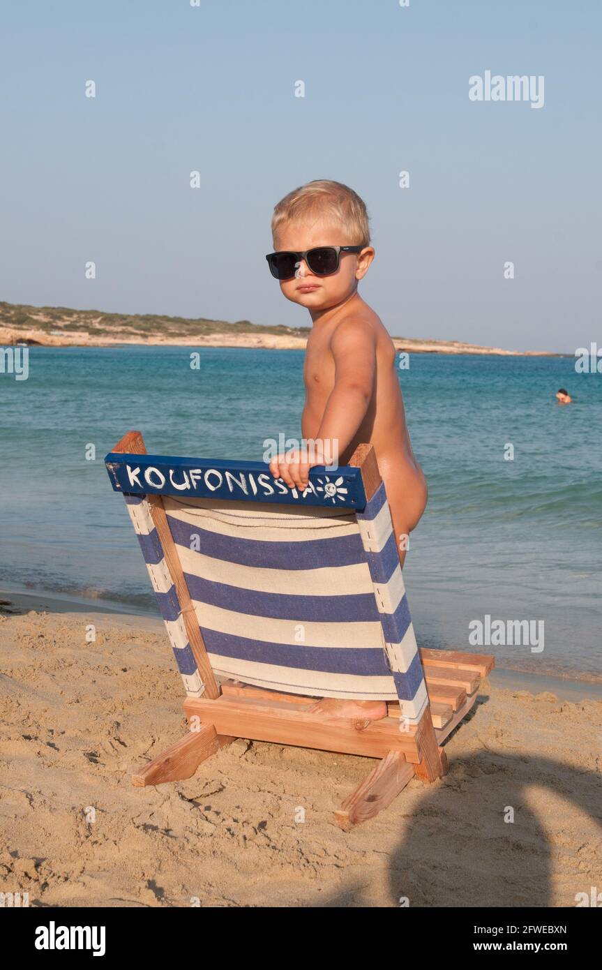 Baby boy, chair, sand, sea, landscape, Koufonissia, Greece, Europe ...