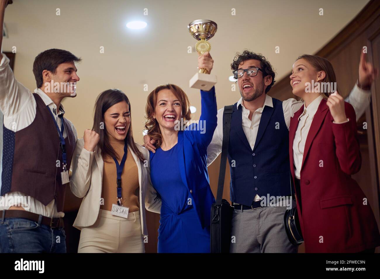 young business team celebrating together success, holding trophy Stock ...